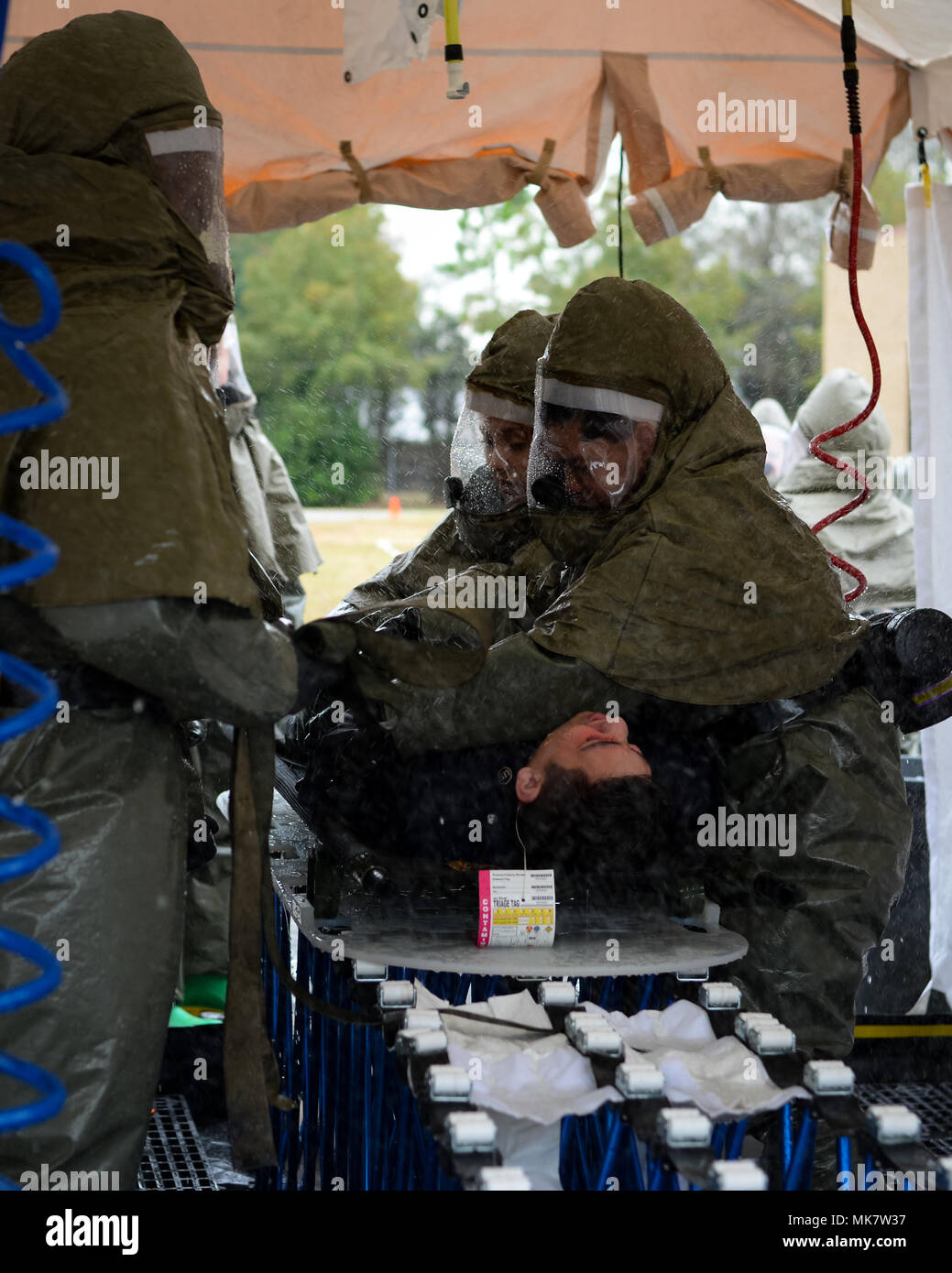 Decontamination team members from the 2nd Medical Group wash a ...