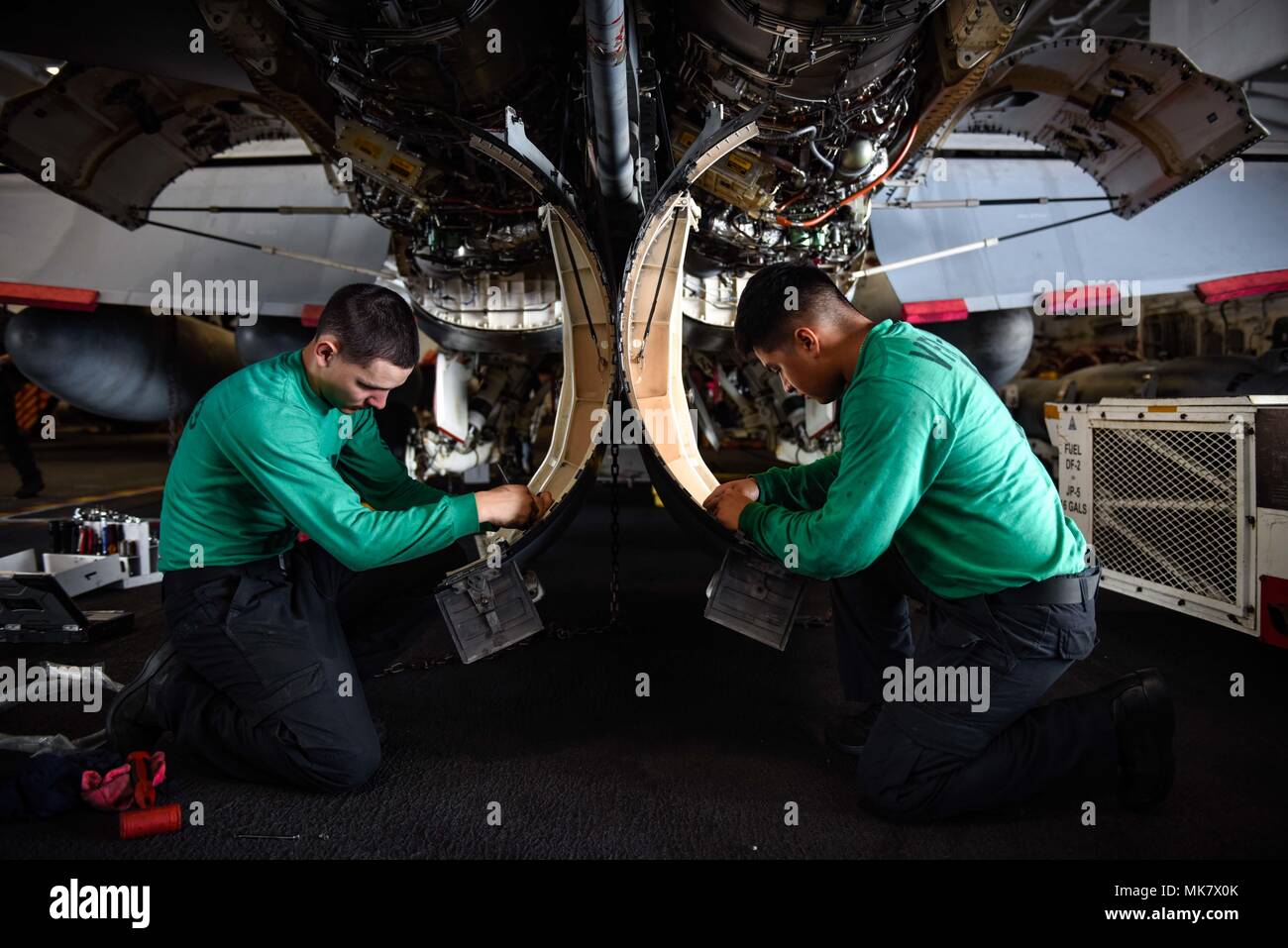 U.S. Navy Aviation Machinist’s Mate 2nd Class Donovan Vassey, left, and ...