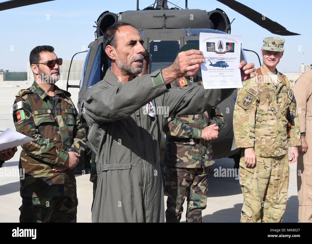 An Afghan Air Force pilot receives a certificate during a UH-60 Black ...