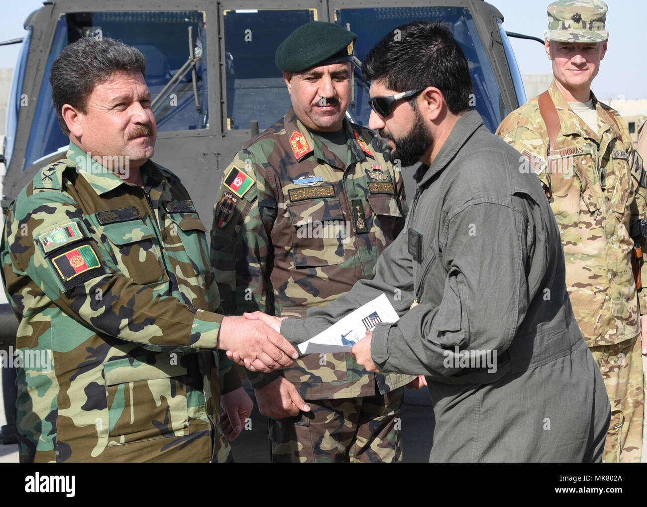 An Afghan Air Force pilot receives a certificate during a UH-60 Black ...