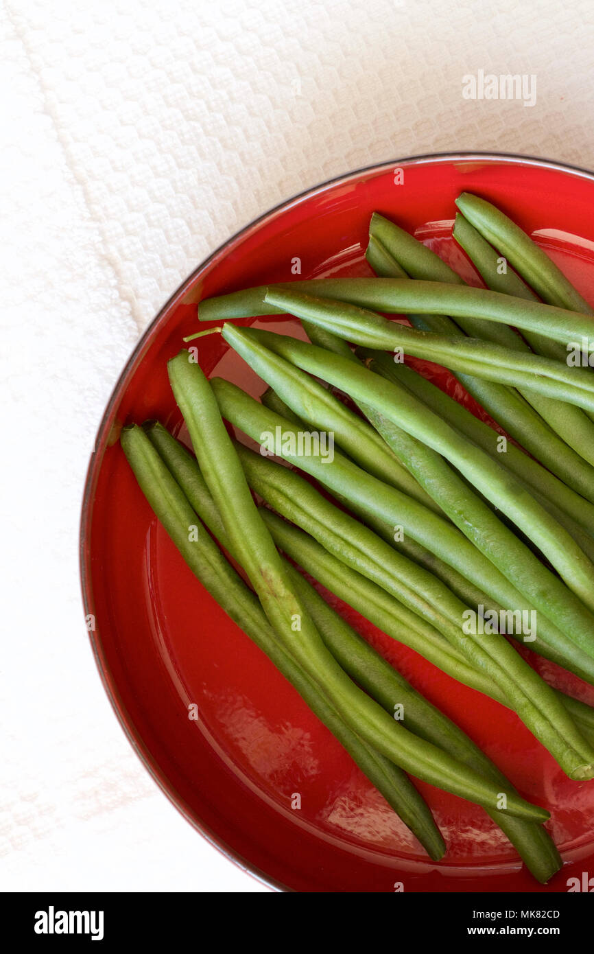 Fresh green French beans on a red plate Stock Photo - Alamy