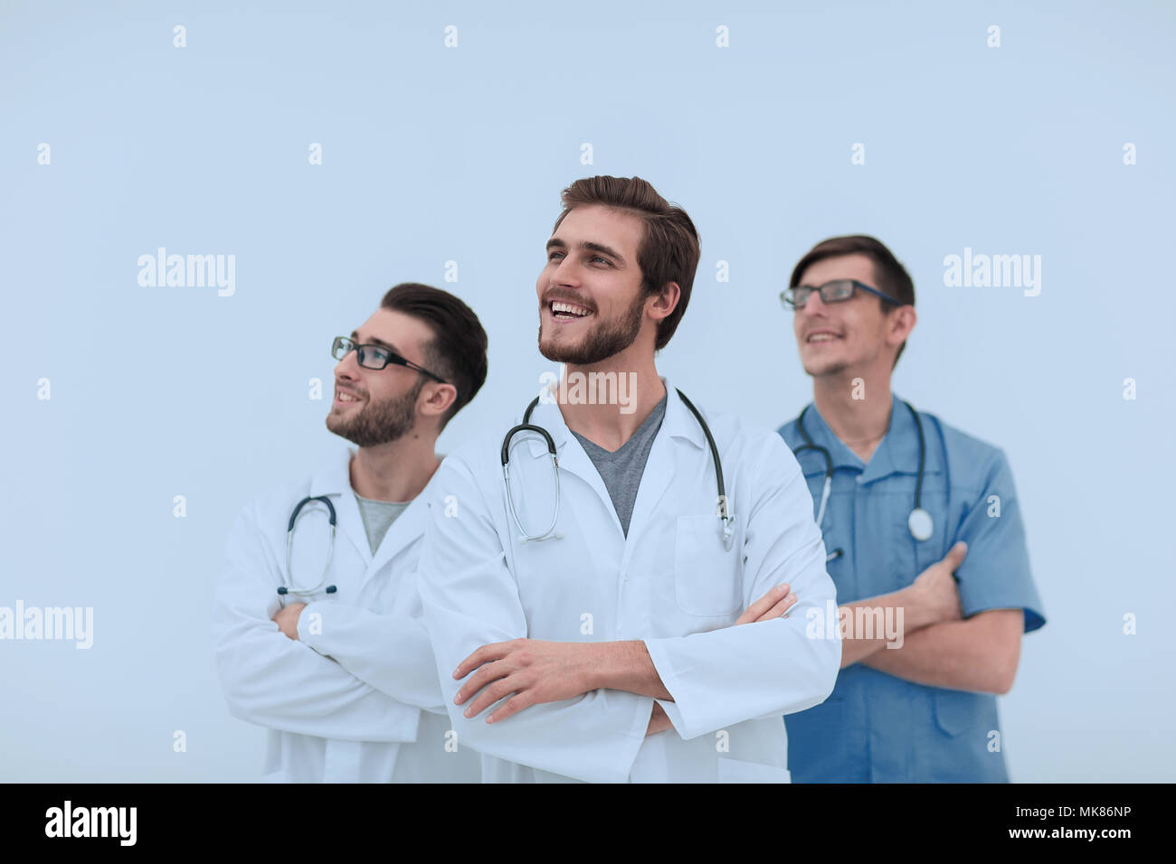 team of doctors looking at copy space Stock Photo - Alamy