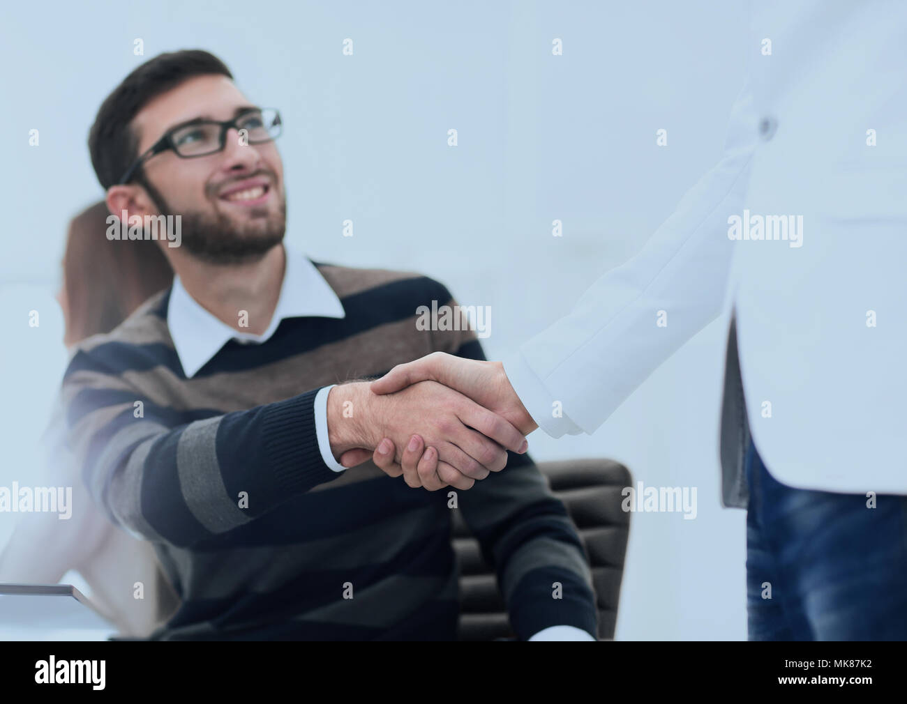 handshake between colleagues in the workplace Stock Photo - Alamy