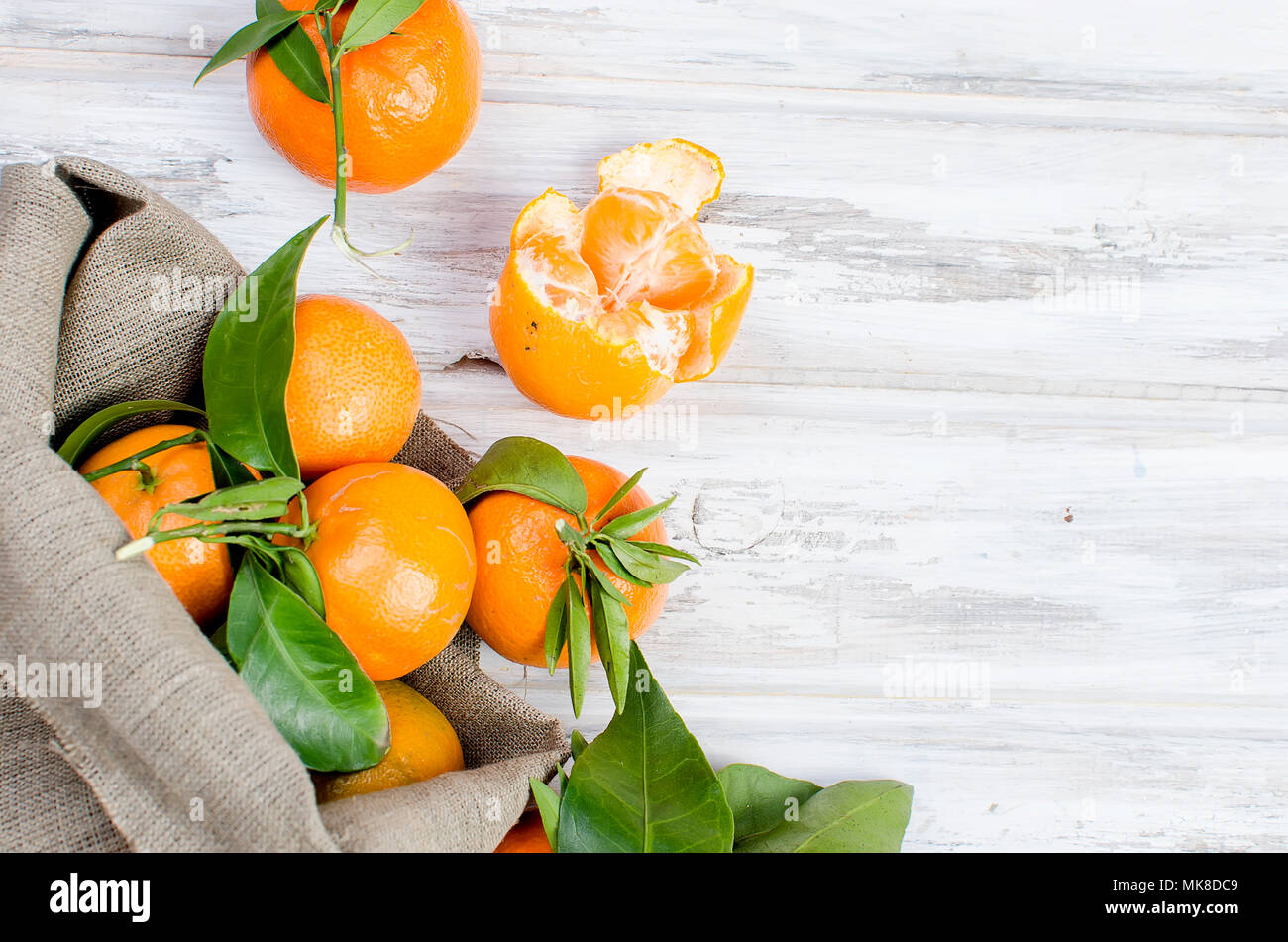 Fresh raw organic Tangerines clementine with green leaves in bag on ...