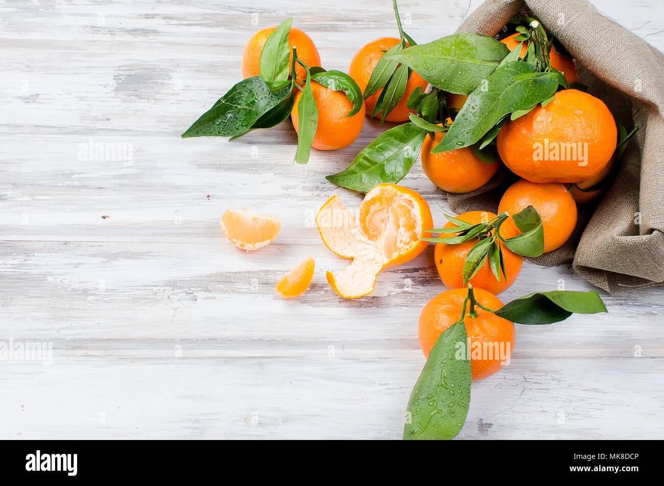 Fresh raw organic Tangerines clementine with green leaves in bag on ...