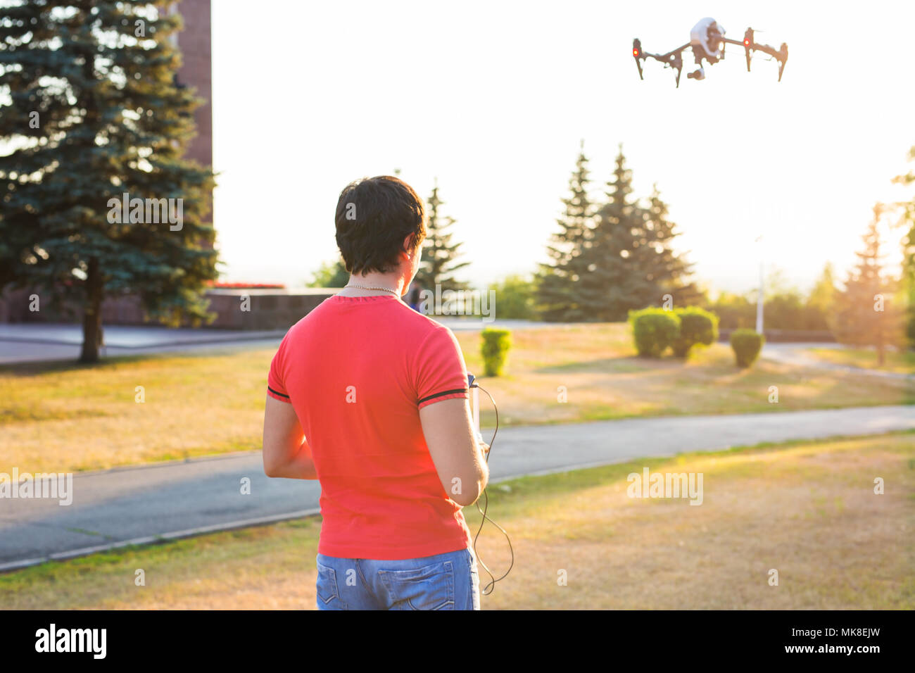 Man Operating Drone Flying or Hovering by Remote Control in Nature ...