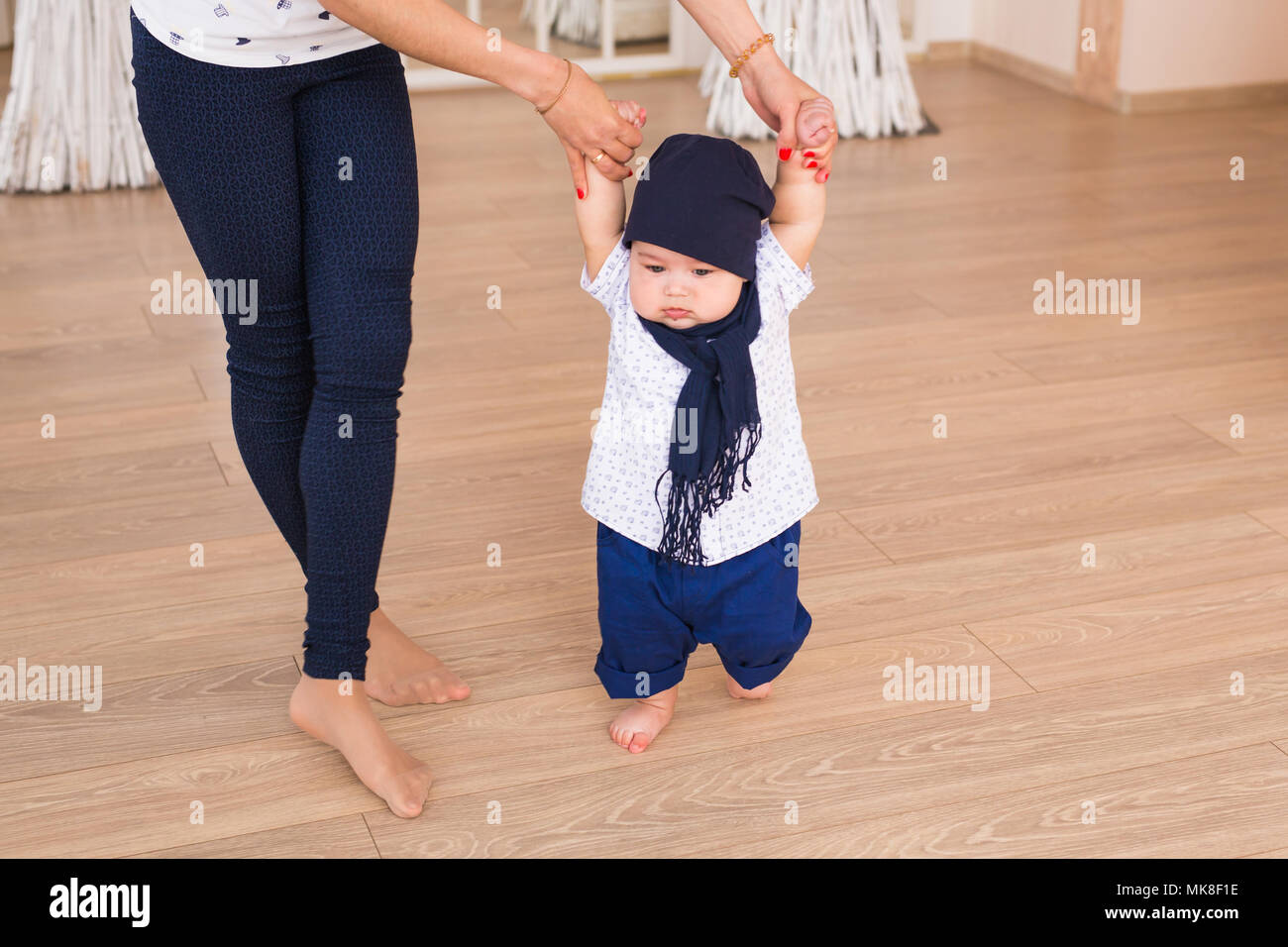 Cute smiling baby boy learning to walk Stock Photo - Alamy