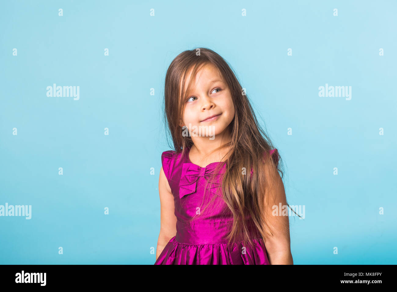 Sweet little girl over blue background Stock Photo - Alamy