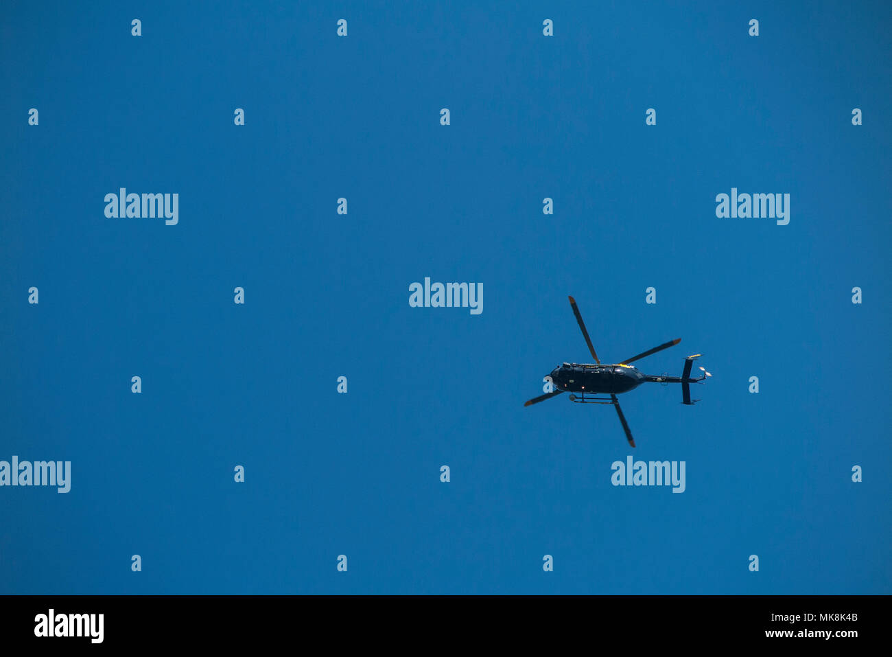 A police helicopter provides aerial assistance to a police patrol on ...