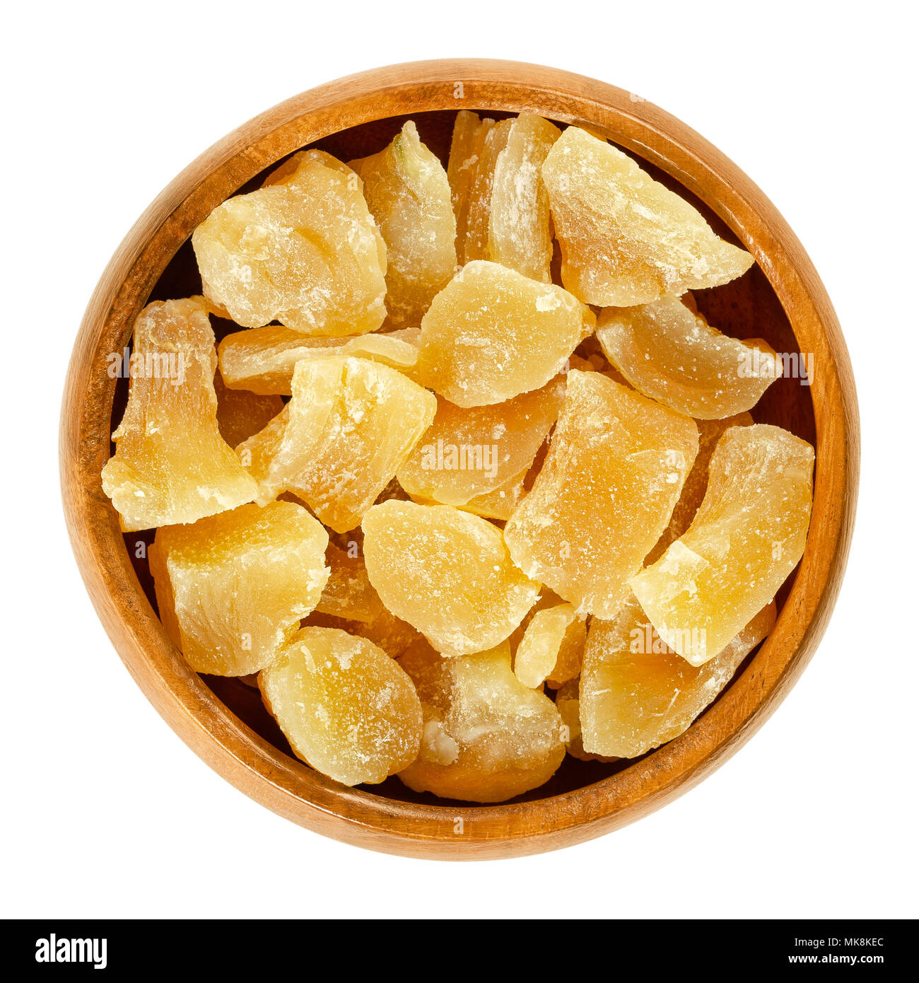 Candied ginger root chunks in wooden bowl. Crystallized roots of ...