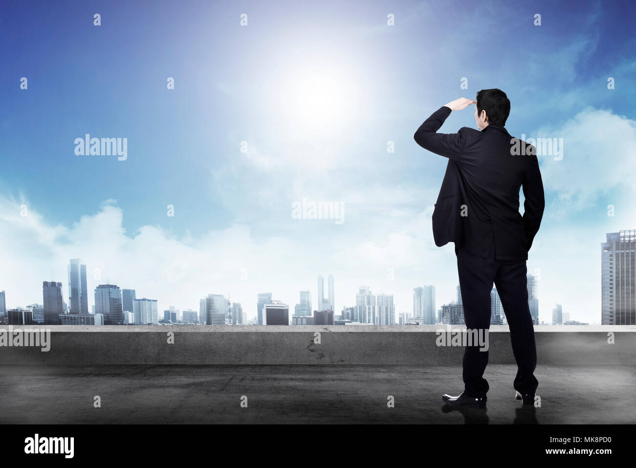 Successful businessman looking out the city from the rooftop Stock ...