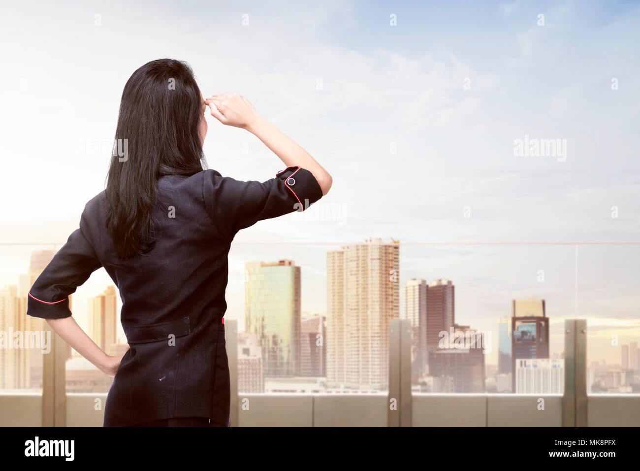 Young asian business woman looking at cityscape from terrace Stock ...