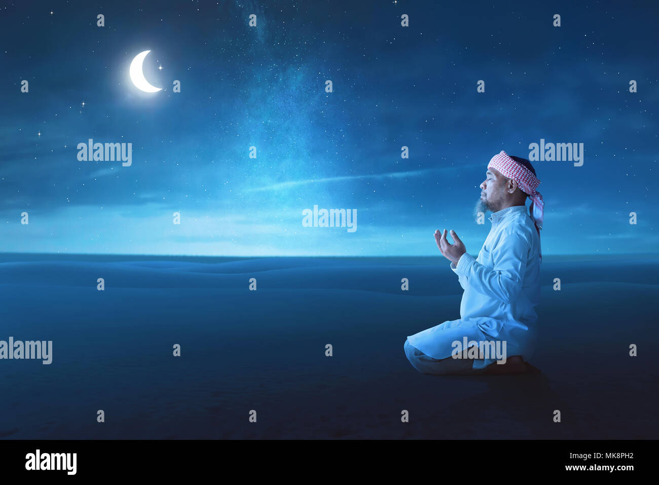 Elderly asian muslim man raise hand and praying at night Stock Photo ...
