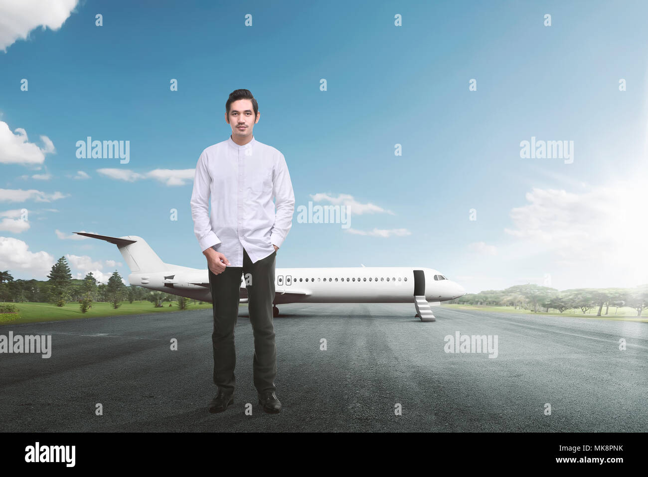 Handsome asian muslim man standing with airplane on the runway Stock ...