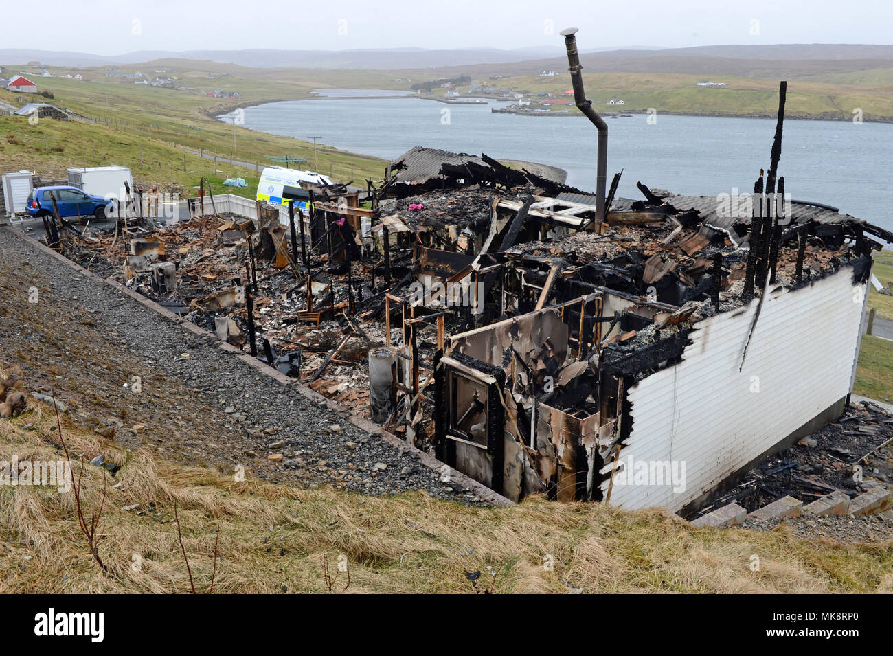 Remians of burnt down wooden house form a house fire and only the shell ...