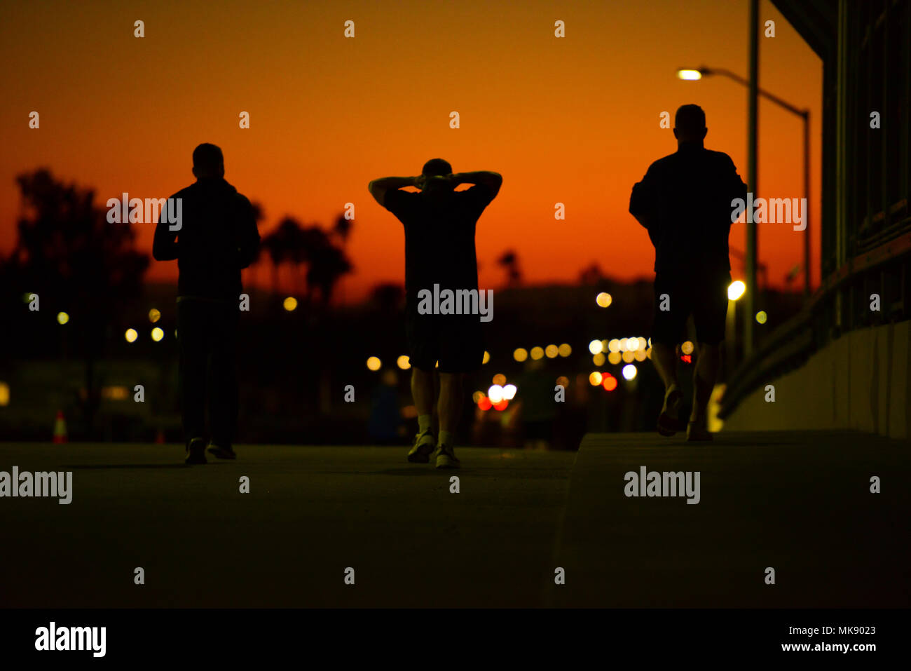 Airmen assigned to the 56th Fighter Wing carry weights across the Troy ...