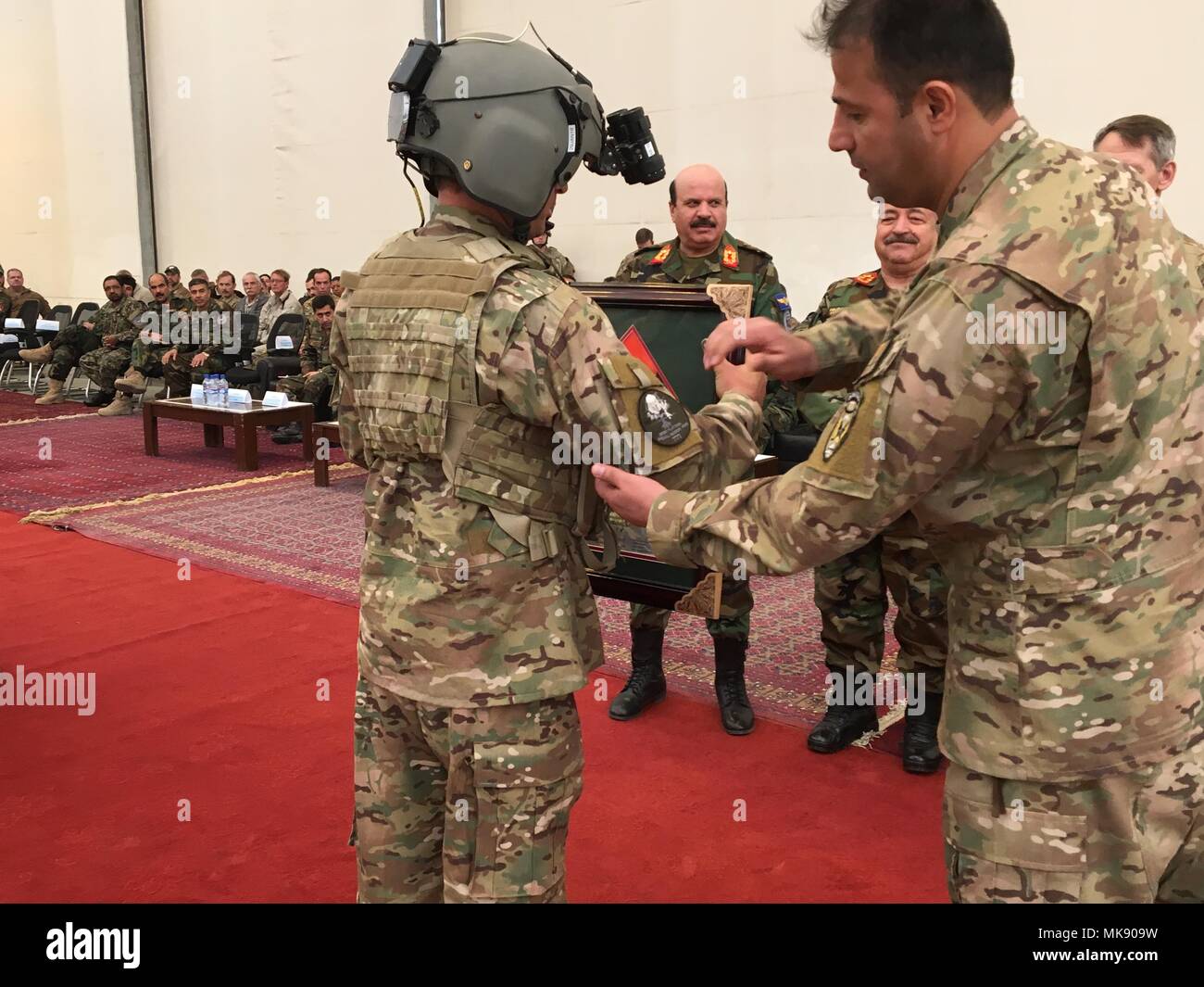 Brig. Gen. Ramin, Afghan Special Mission Wing commander, presents a ...
