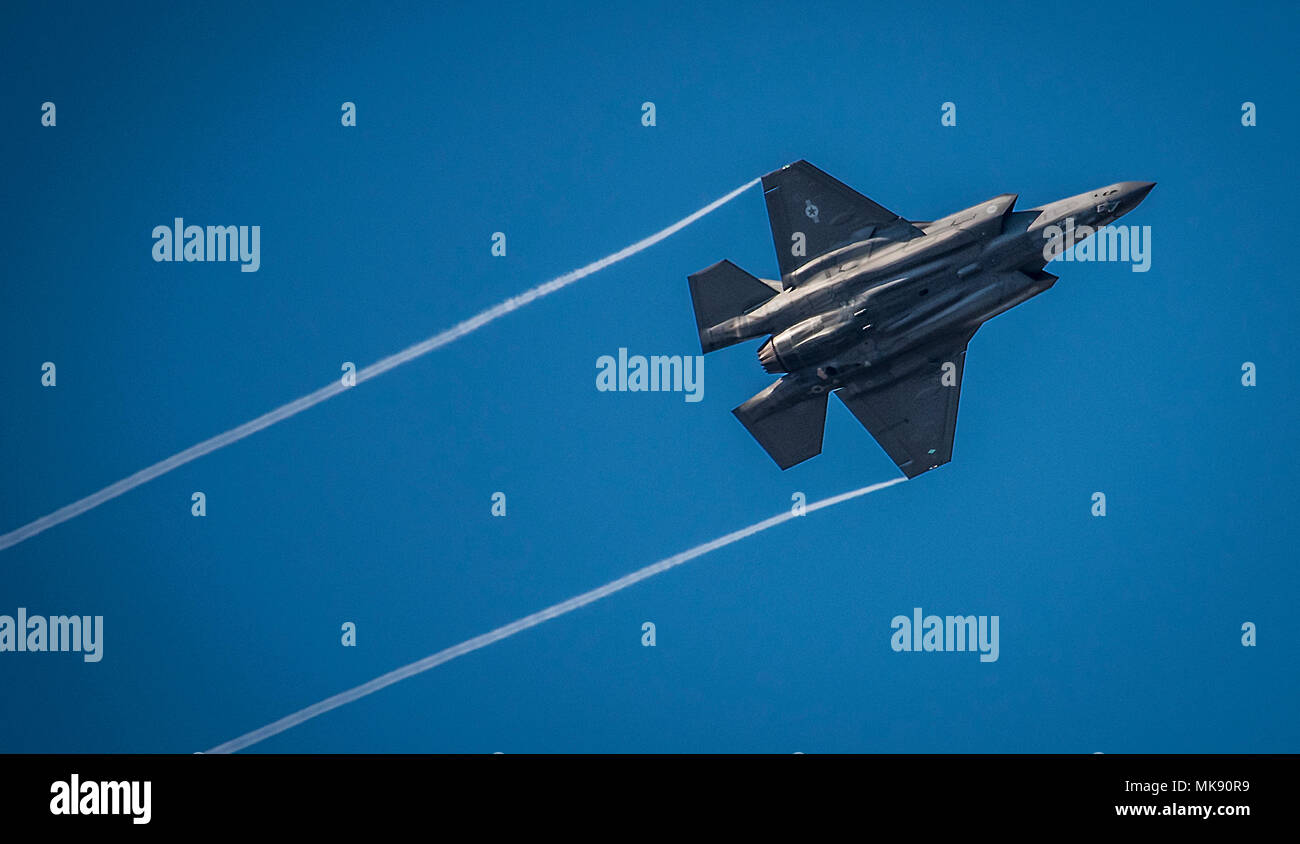 An F-35 Lightning II streaks across the sky while doing maneuvers to ...