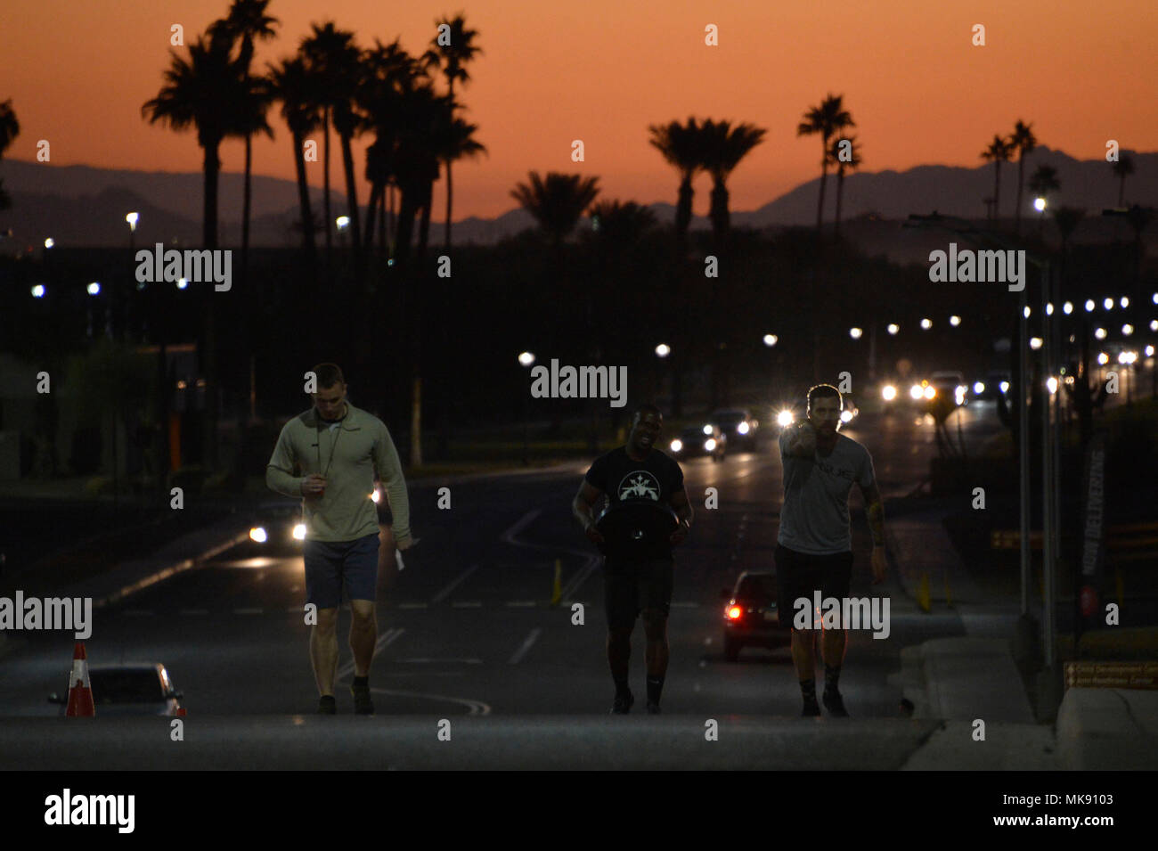 Airmen assigned to the 56th Fighter Wing carry weights across the Troy ...