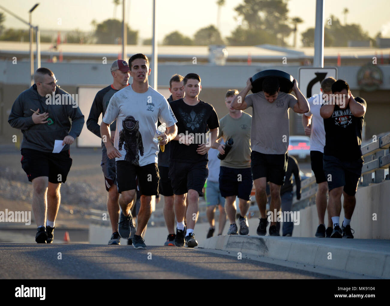 Airmen assigned to the 56th Fighter Wing jog across the Troy Gilbert ...