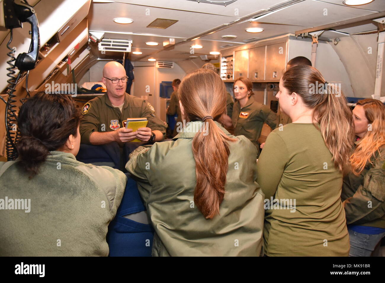 An aircrew member with the 964th Airborne Air Control Squadron gives a ...