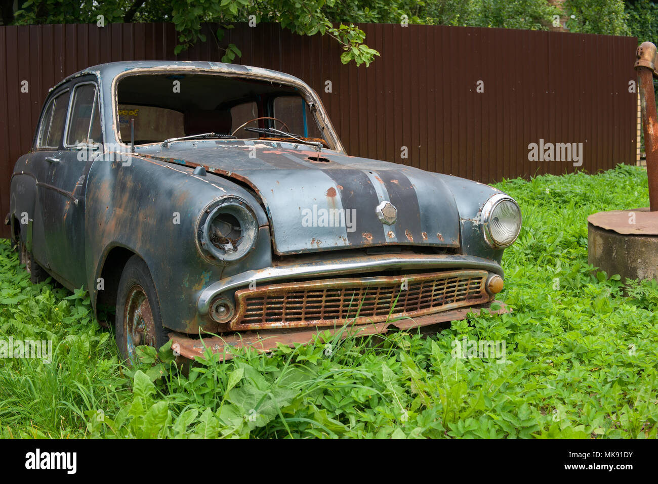 Old rusty overgrown abandoned soviet retro car Stock Photo - Alamy