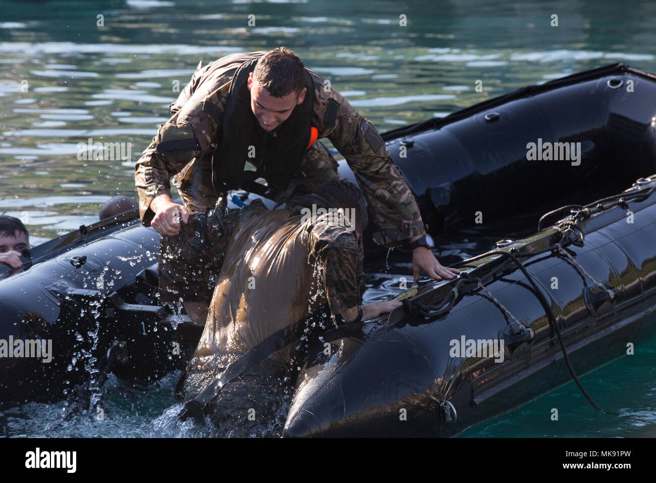 A Royal British Marine assists a U.S. Marine with Black Sea Rotational ...