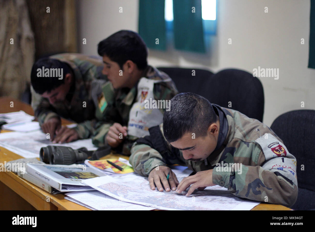 Afghan Commandos conduct a map reconnaissance to build their sniper ...