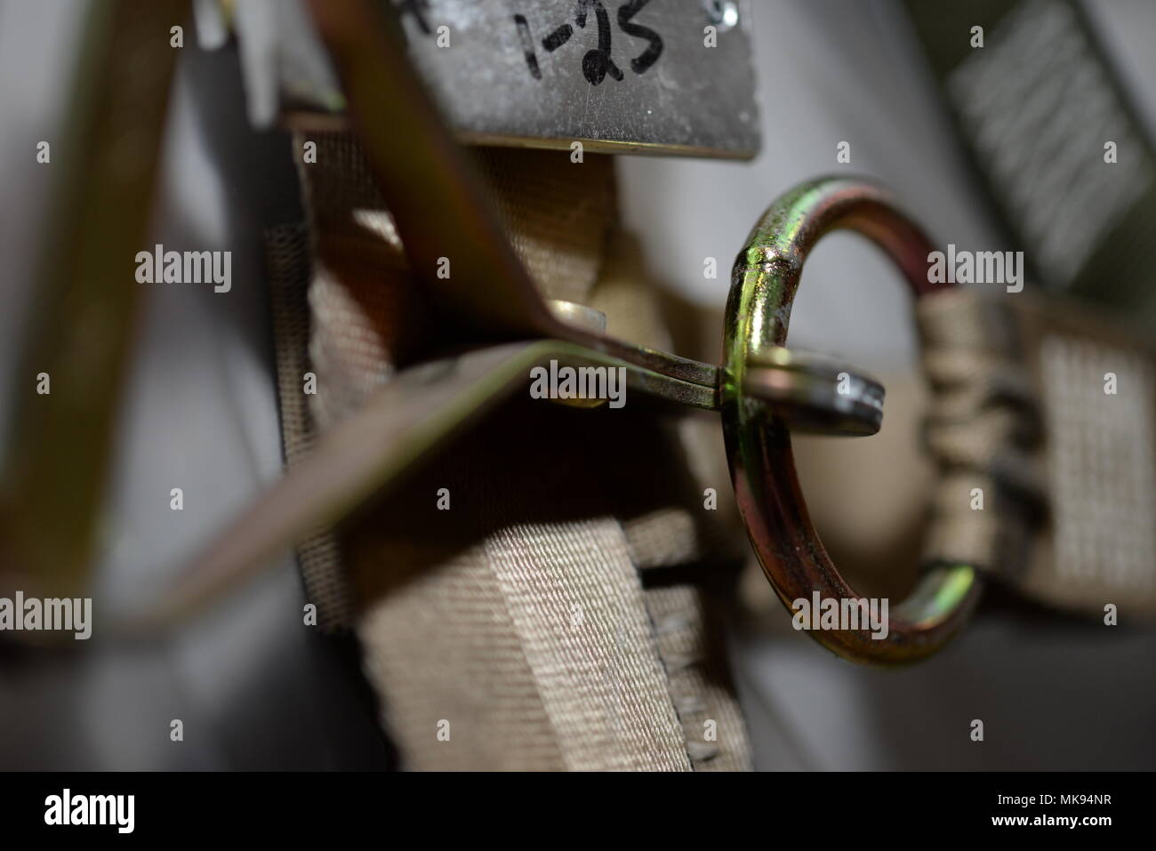 A clasp secures cargo straps on a pallet of individual protective ...