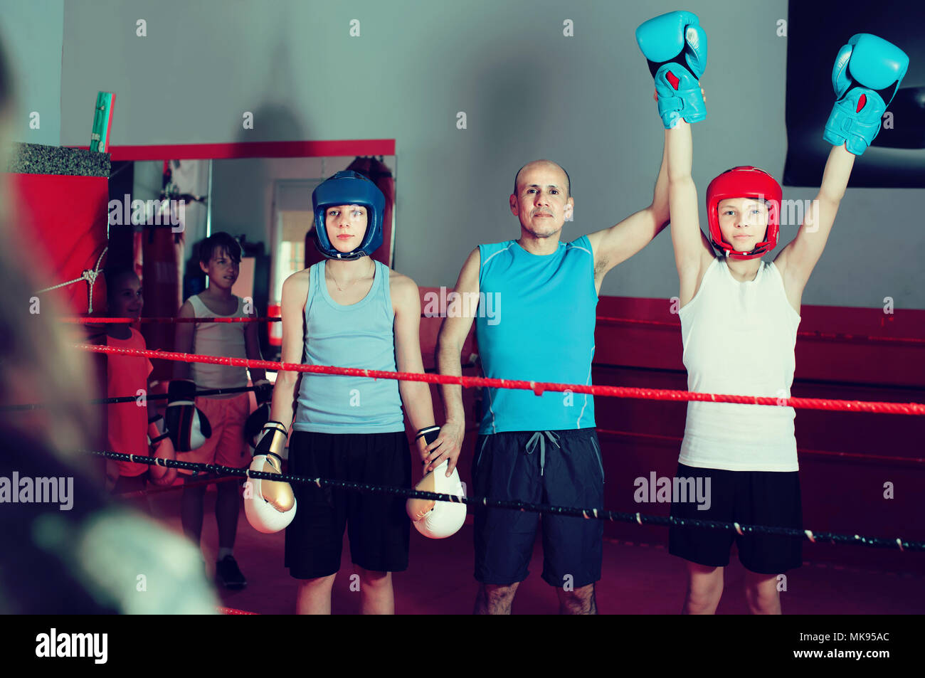 Young smiling boxer with coach standing at boxing ring Stock Photo - Alamy