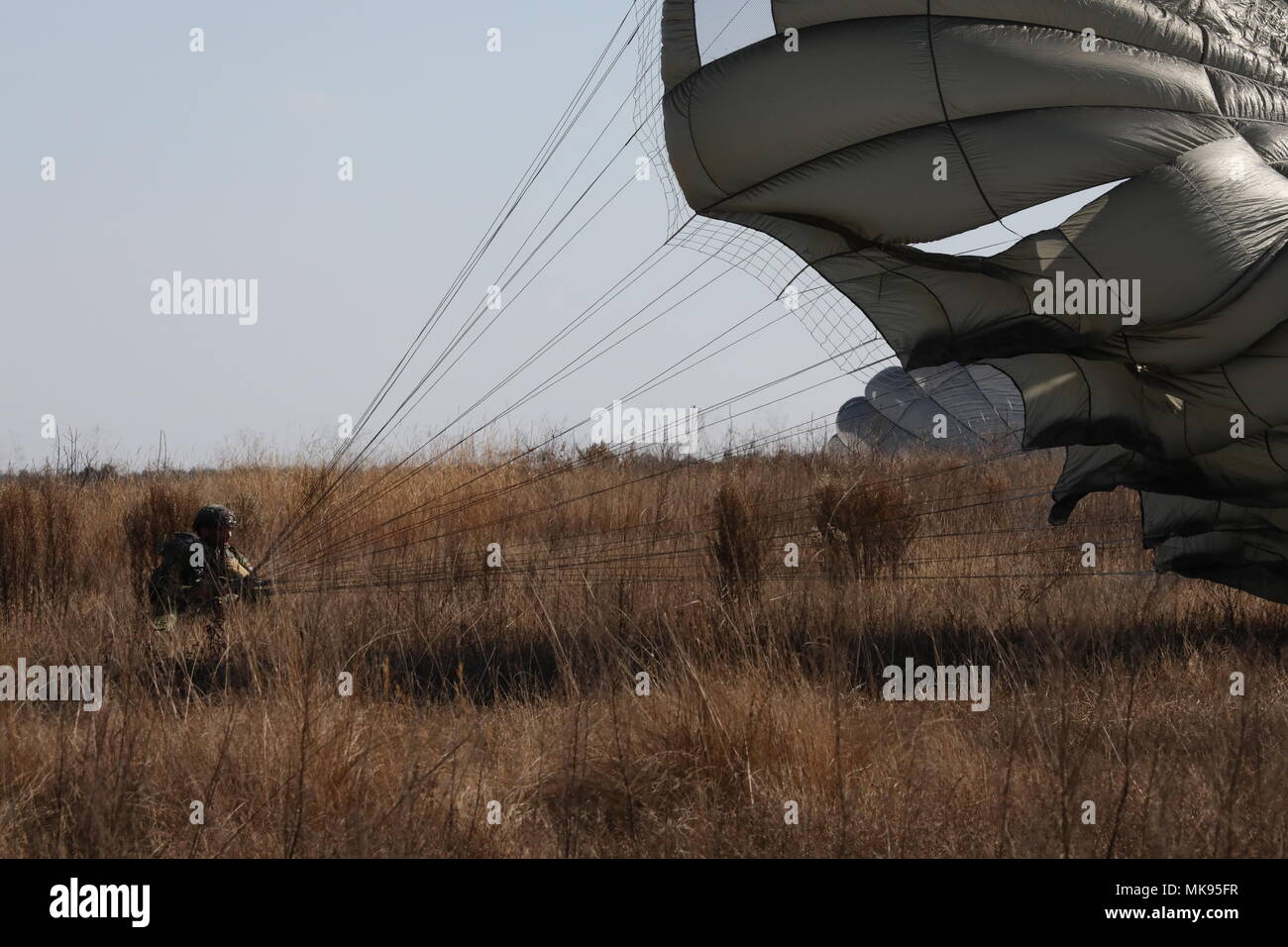 A Foreign Jumpmaster lands after jumping from the UH-60 Black Hawk on ...