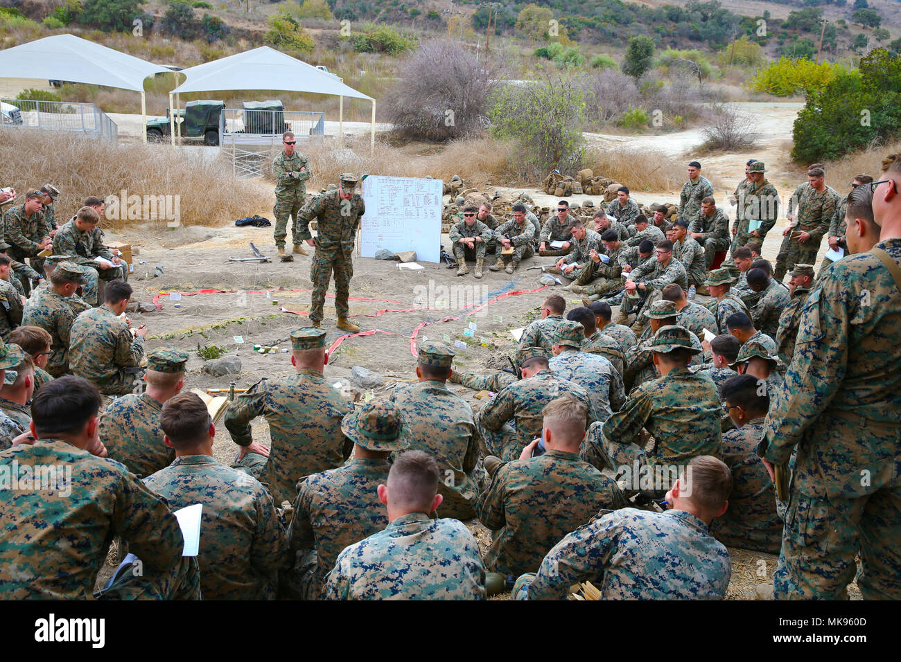 U.S. Marine Corps Capt. Nicholas Leads conducts a sand-table exercise ...