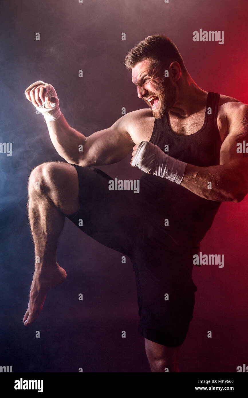 Sport concept. Sportsman muay thai boxer fighting on black background ...