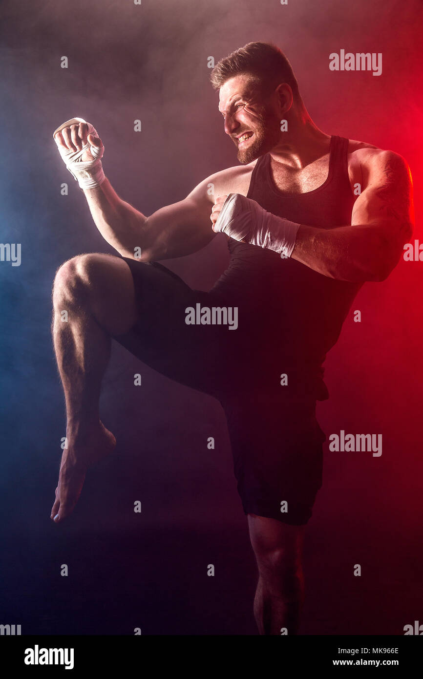 Sport concept. Sportsman muay thai boxer fighting on black background ...