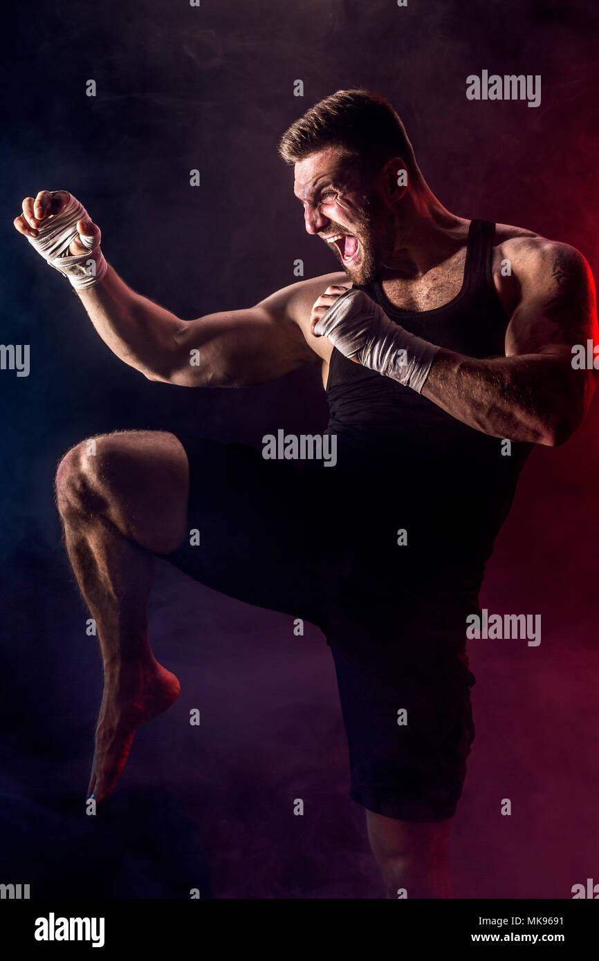 Sport concept. Sportsman muay thai boxer fighting on black background ...