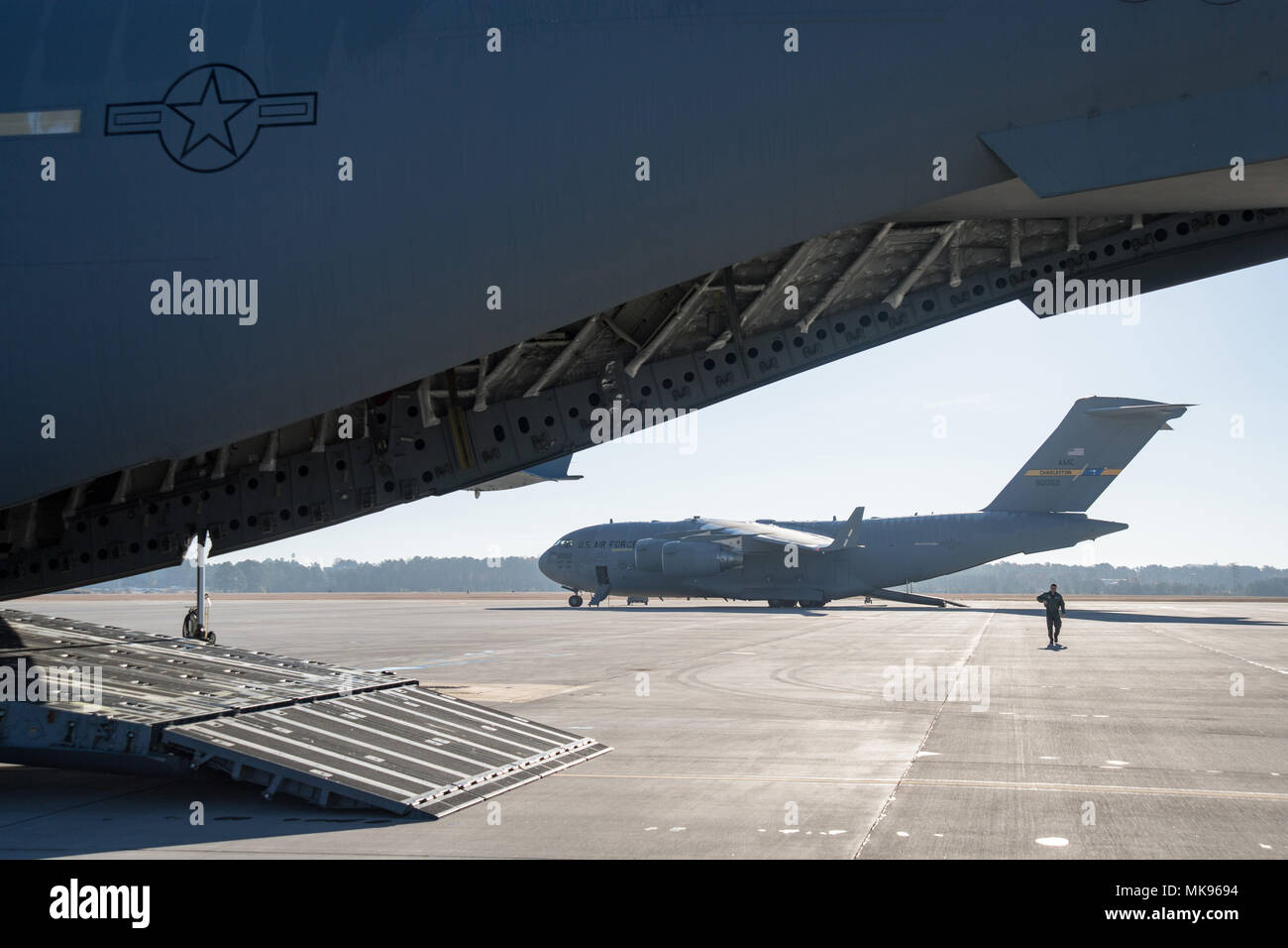POPE ARMY AIRFIELD, N.C. — An aircrew member walks to a C-17 ...
