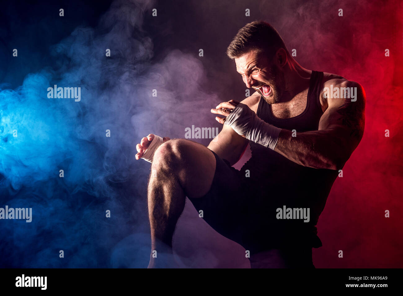 Sport concept. Sportsman muay thai boxer fighting on black background ...