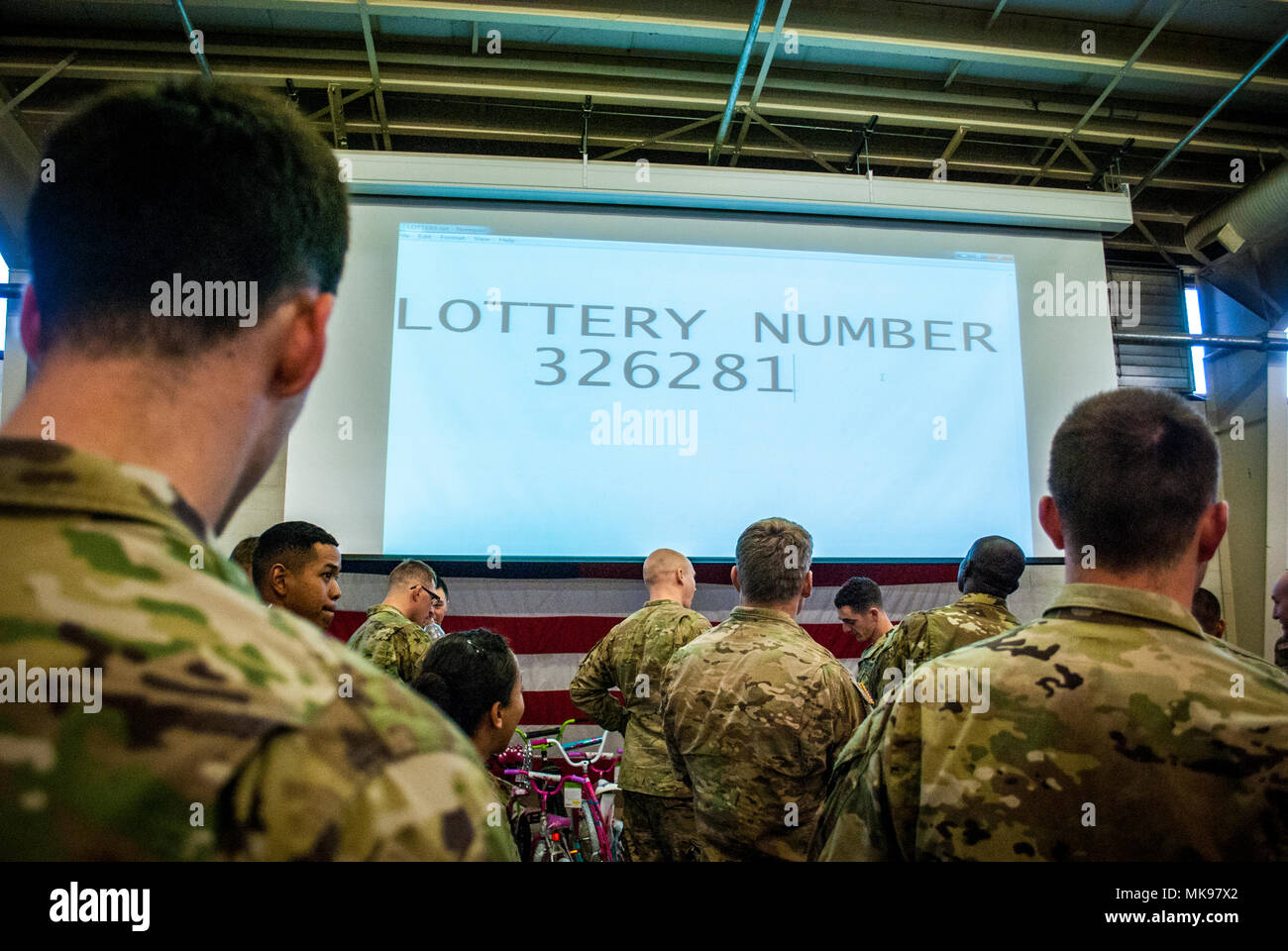 Soldiers check their tickets against the called number during the ...