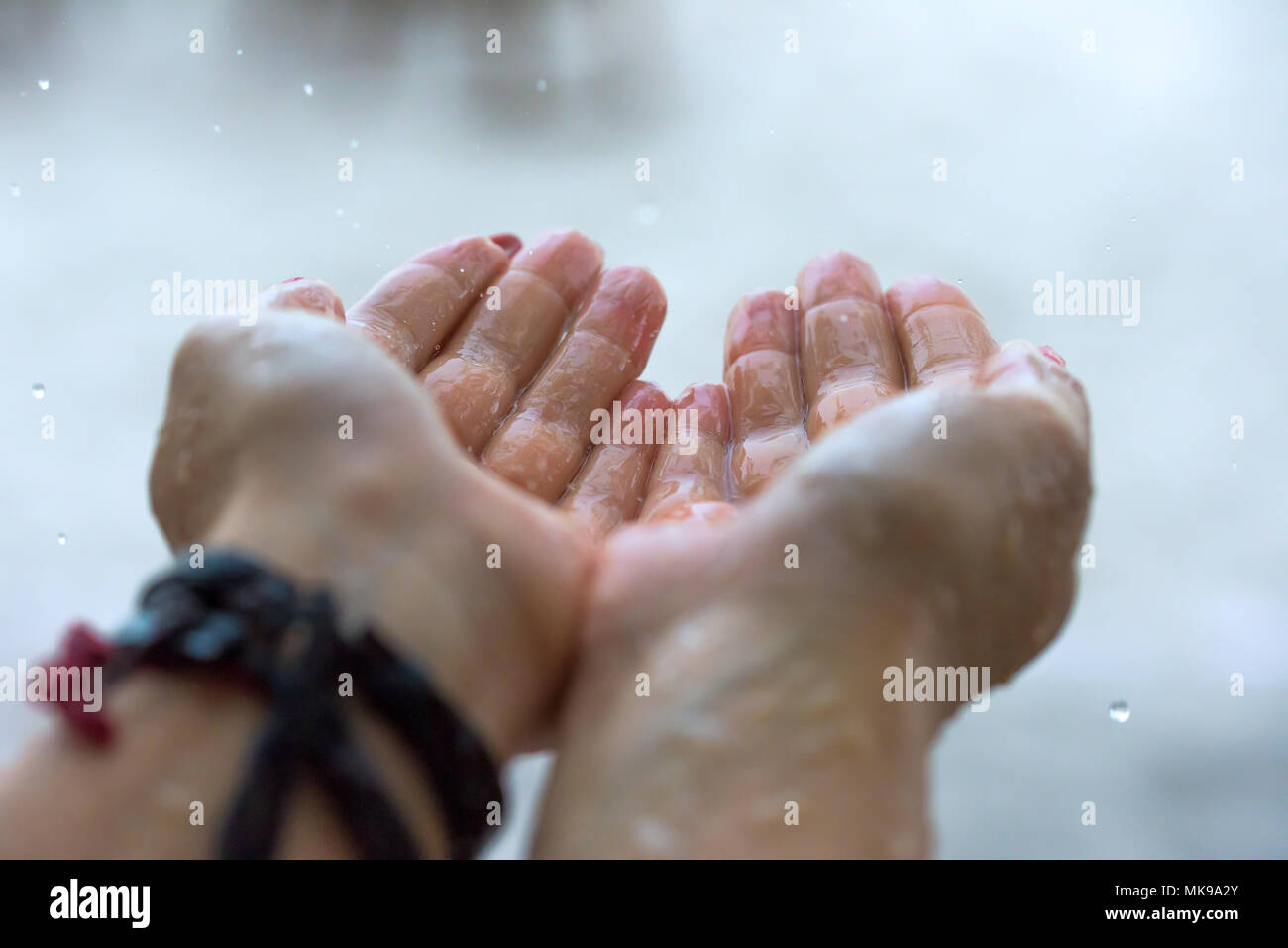 Rain drops falling on woman’s hand Stock Photo - Alamy