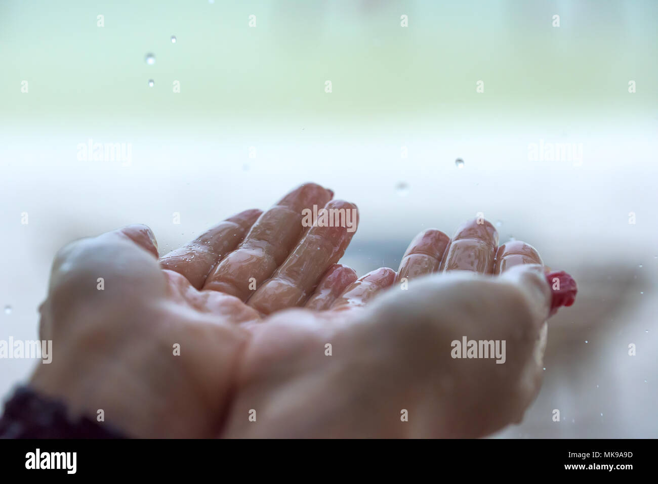 Hands catching clean falling water hi-res stock photography and images ...