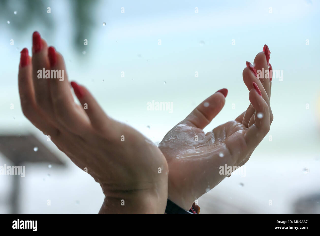 Rain drops falling on woman’s hand Stock Photo - Alamy