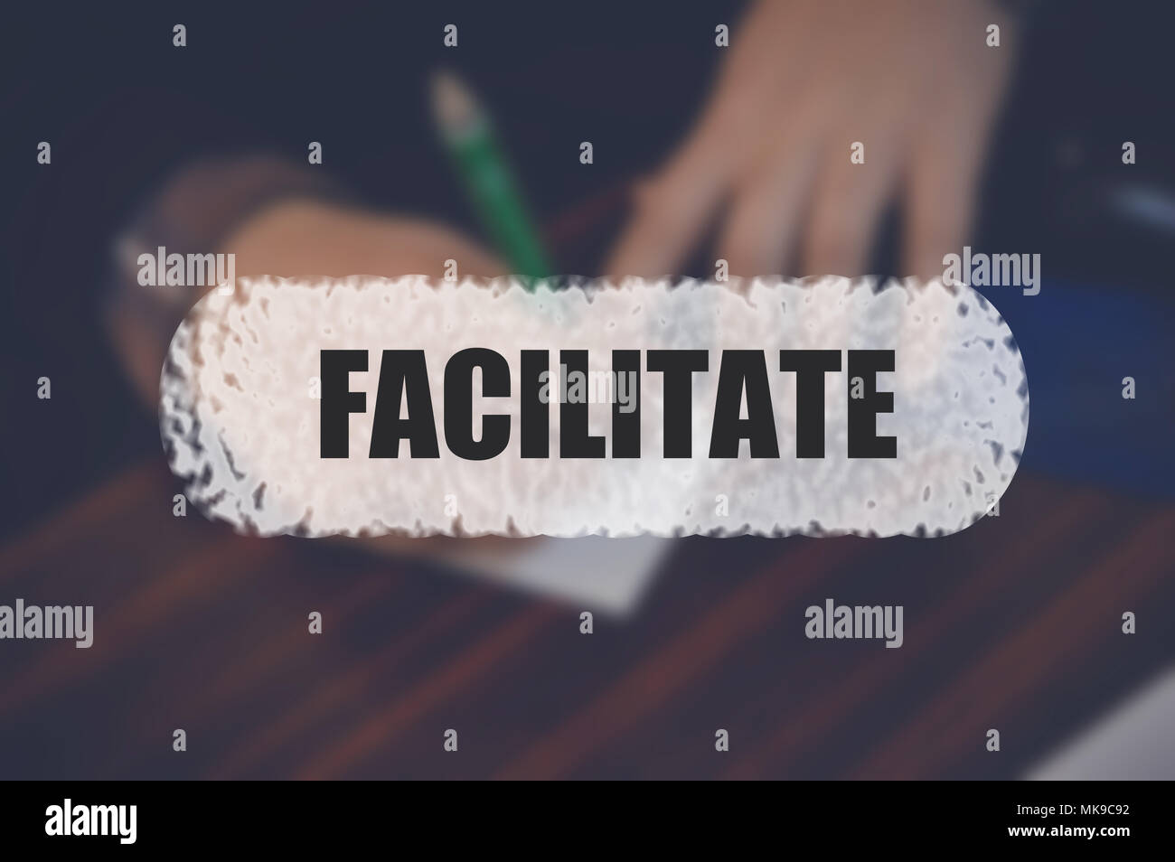 Facilitate word with blurring business background Stock Photo - Alamy