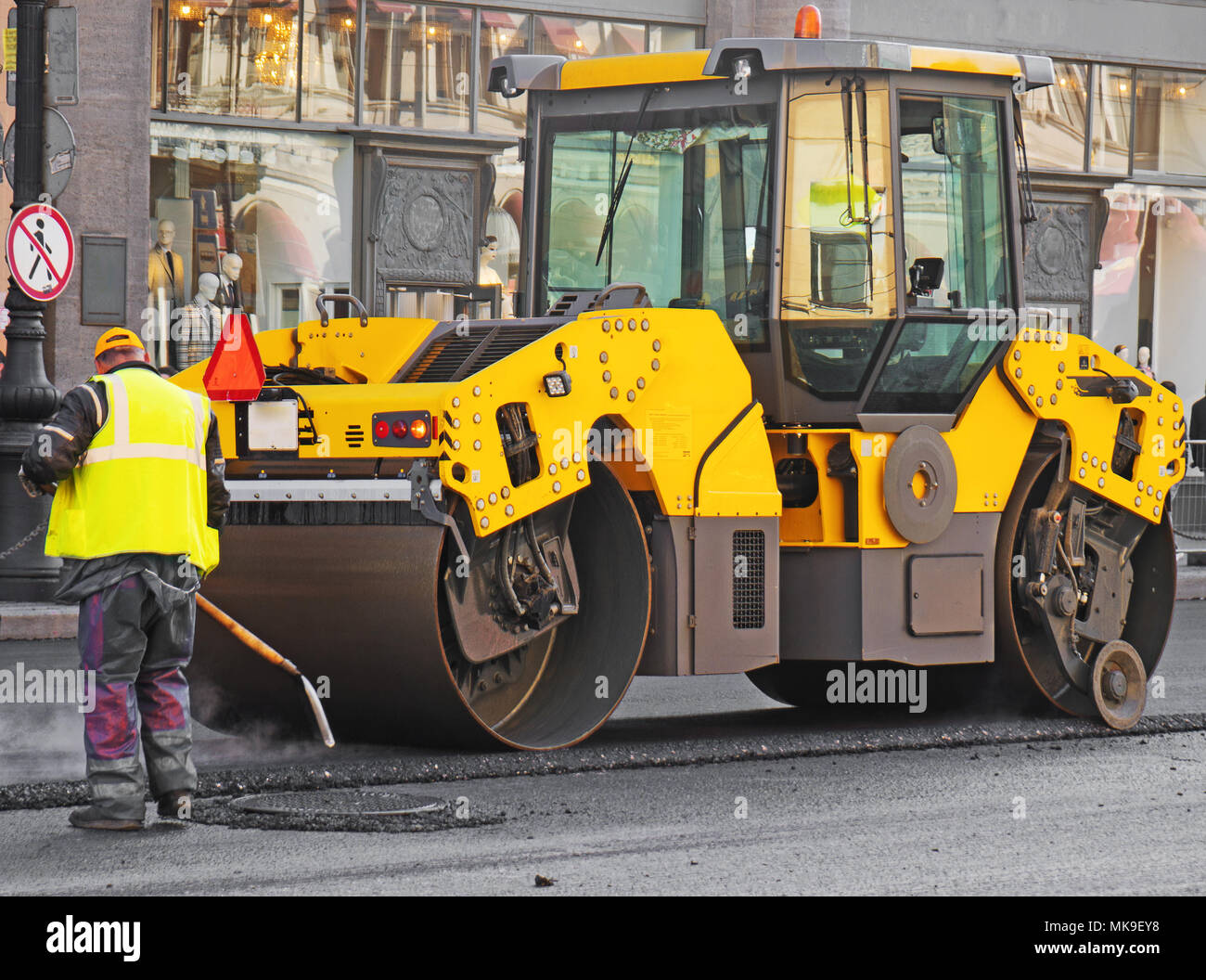 Road re-construction. Road roller stacking hot asphalt Stock Photo - Alamy