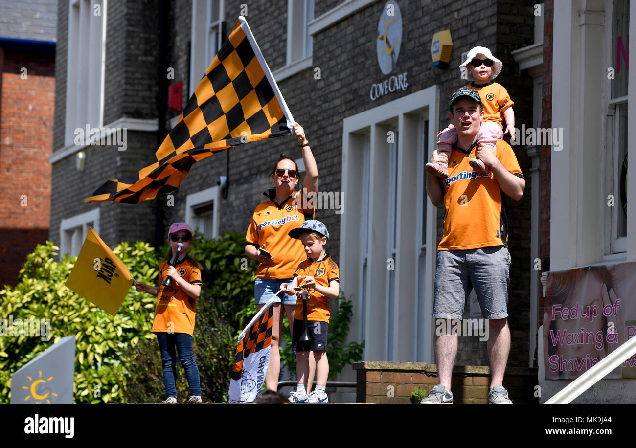 A family of Wolverhampton Wanderers fans wave flags during the winner's ...