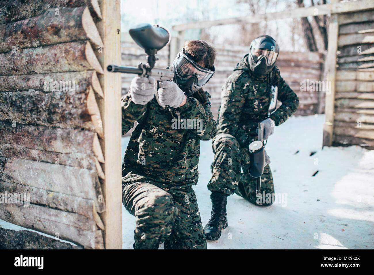 Paintball team, players in winter battle. Extreme sport game, soldiers ...