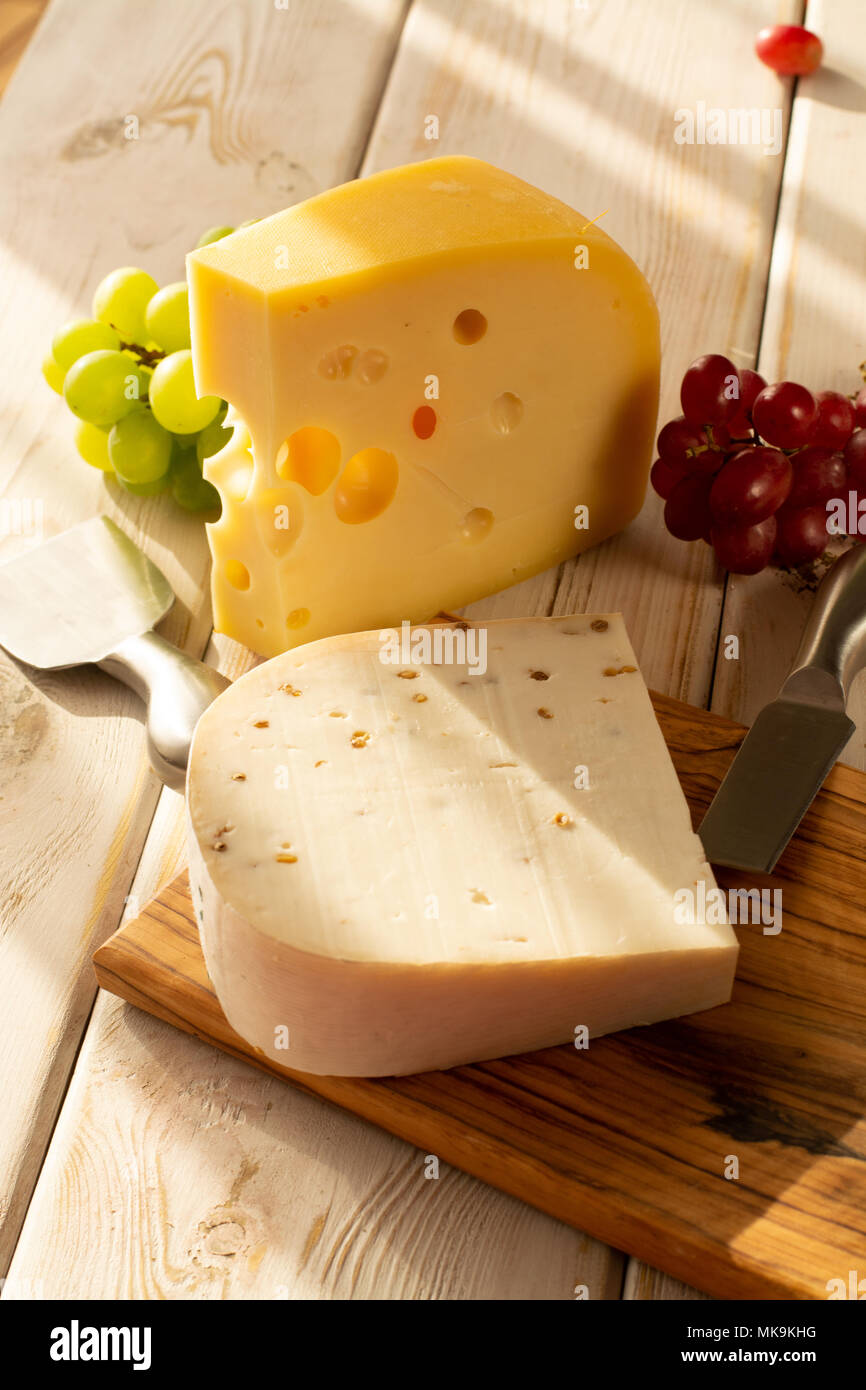 Dutch hard cheese Maasdam or Emmentaler, cheese with holes and white ...