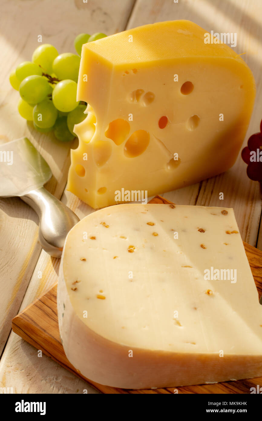 Dutch hard cheese Maasdam or Emmentaler, cheese with holes and white ...
