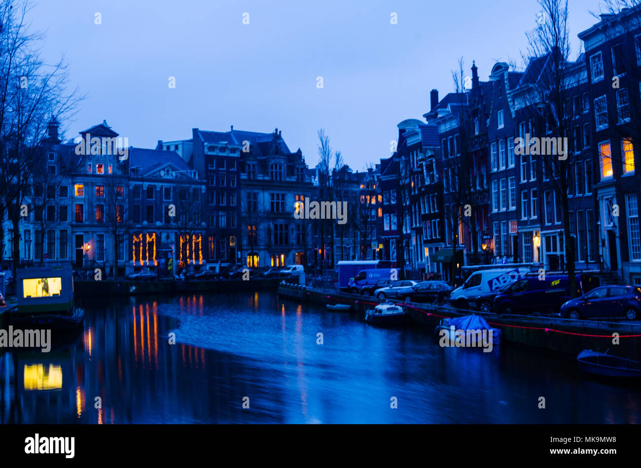 Traditional old dutch buildings and construction along river canal dike ...