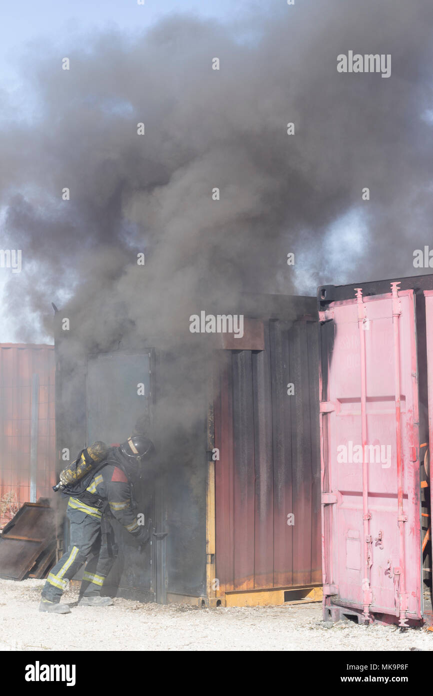 Firefighter putting out fire training station extinguisher backdraft ...