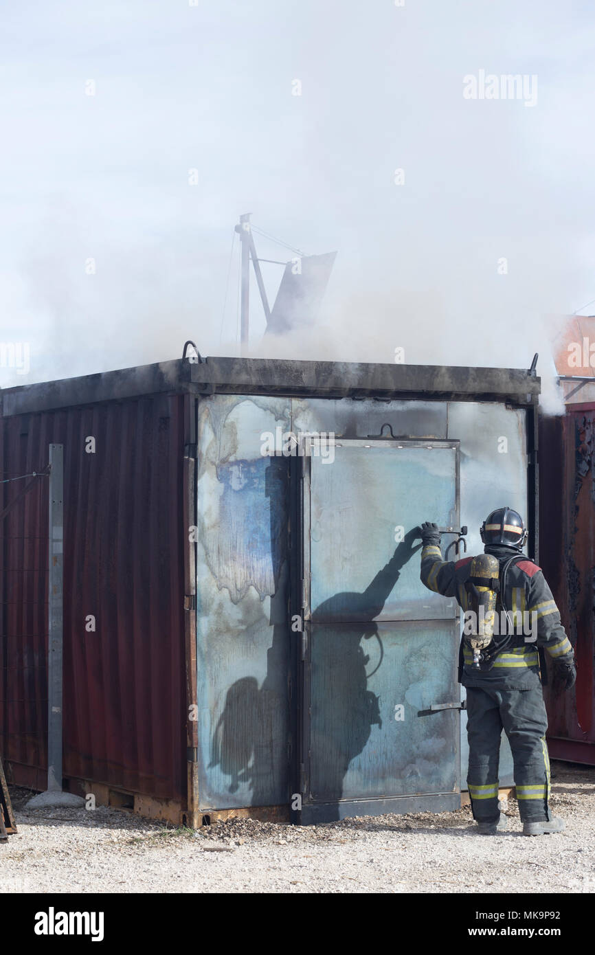 Firefighter putting out fire training station extinguisher backdraft ...